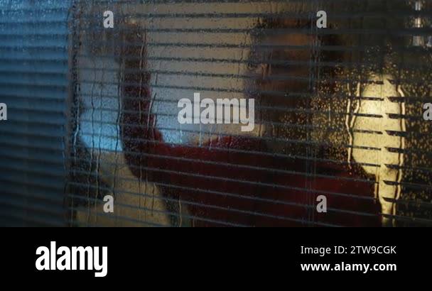 Boy watching storm through window Stock Video Footage - Alamy