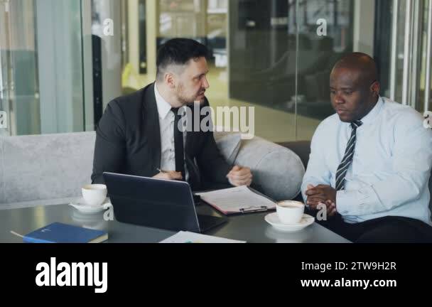 Angry businessman in black business suit criticizes severely his ...