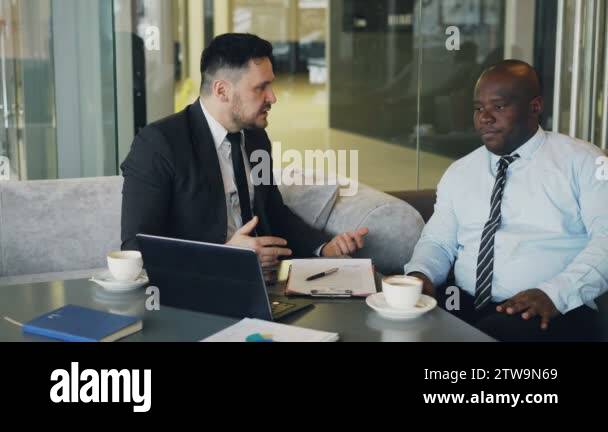 Angry bussinessman in suit scolding his african american employee and ...