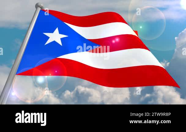 The flag of Puerto rico develops in the wind against a blue sky with ...