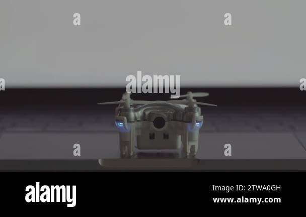 Futuristic transportation concept.Micro drone take off from laptop ...