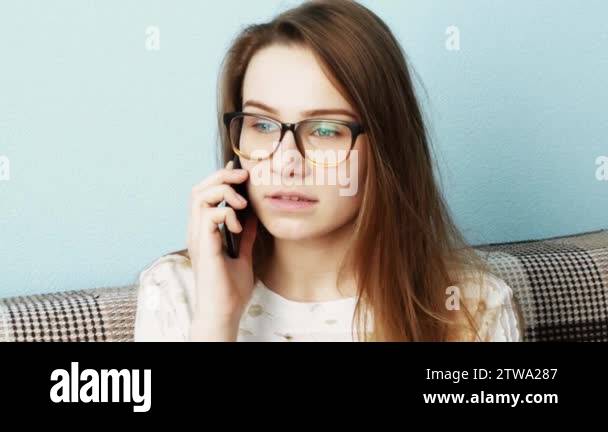 Worried young woman looks nervously, bites finger, isolated/Female is ...