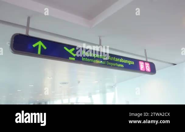 International departure signage at an airport. The signage is in ...