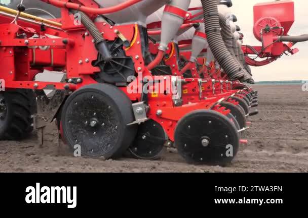 close-up, tractor cultivator cultivates, digs the soil. tractor plows ...