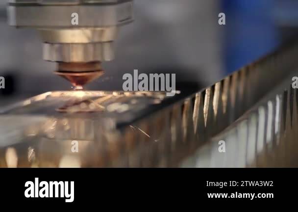 Cutting of metal. Sparks fly from laser. Industrial laser cutter with ...