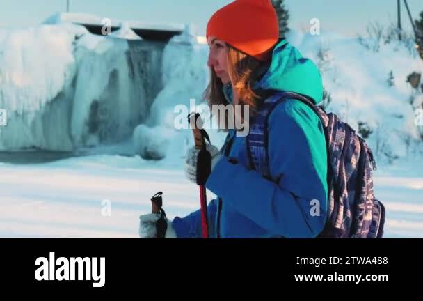 a young girl climber and a hiker. It is walking in the snow with ...