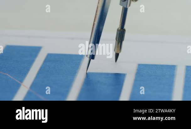 Macro of the compass drawing a circle on the blue graphic or a chart ...