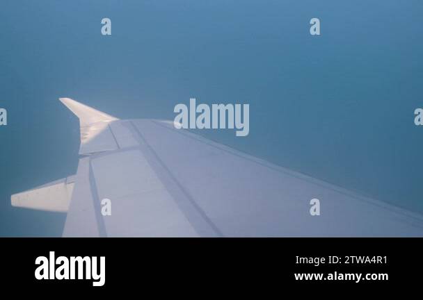 Wing of Wing of plane. A view of the sea and mountains from the plane ...