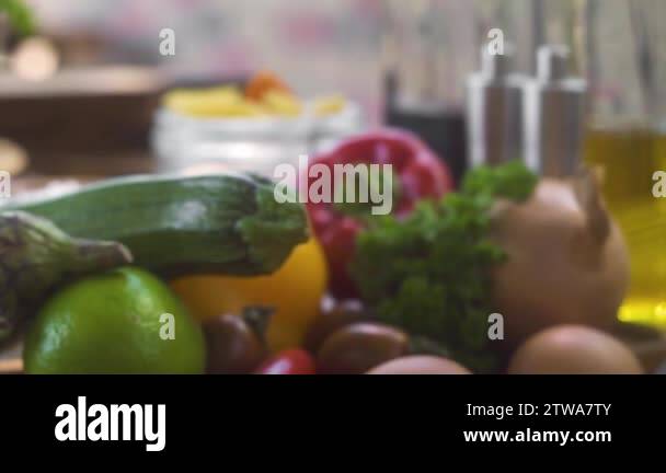 Male hand taking salt for salting food while cooking vegetarian salad ...