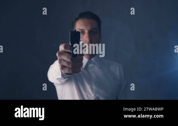 Mafia man pointing gun into a camera. Focus on gun Stock Video Footage ...
