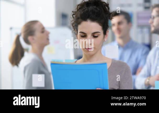 Young smiling female trainee and office worker in the office, business ...