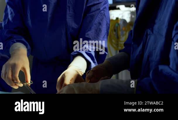 Front view of Multi-ethnic surgeons performing operation in operation ...