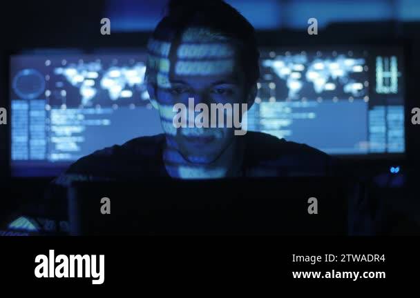 Male Hacker Programmer Working At Computer While Blue Code Characters Reflect On His Face In 
