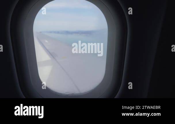 Wing of Wing of plane. A view of the sea and mountains from the plane ...