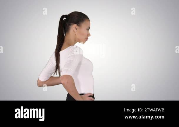 Beautiful brunette girl walking with hands on hips on gradient ...