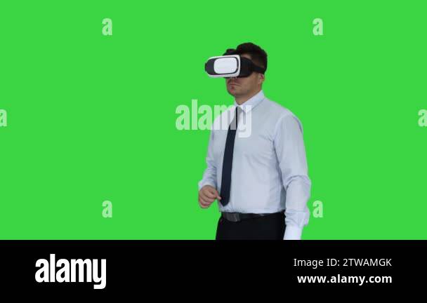 Businessman in VR glasses and interacting with virtual reality objects ...