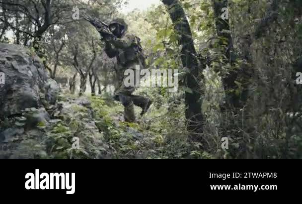 Squad of fully armed commando soldiers during combat in a forest ...