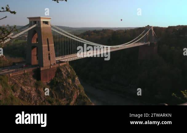 Camera slides behind tree from Clifton Suspension Bridge behind. Shot ...