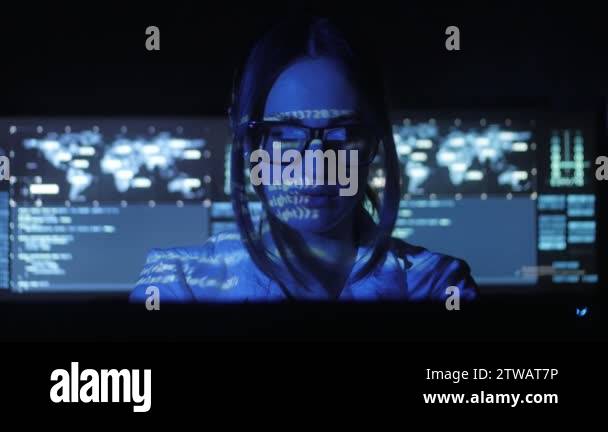 Woman Hacker Programmer In Glasses Is Working On Computer In Cyber Security Center Filled With