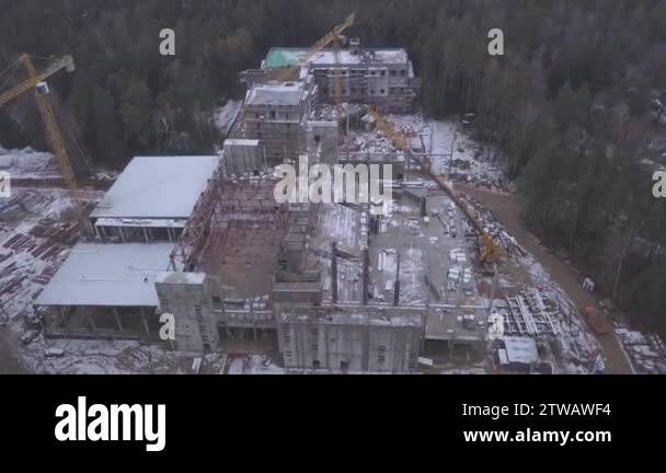 Flying high above big and dusty heavy industry construction site zone ...