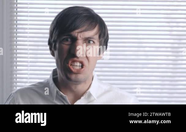 Angry Boss screaming and swearing on the background of blinds in the ...