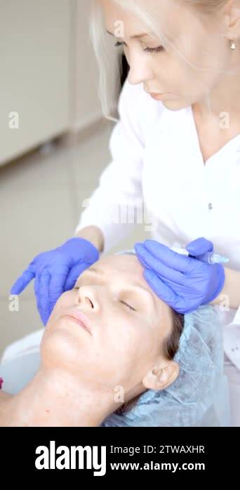 The cosmetologist makes injections, anti-aging procedures for ...