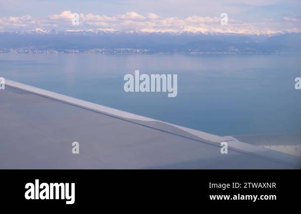 Wing of Wing of plane. A view of the sea and mountains from the plane ...