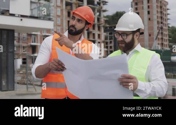 Architect expert engineers talking and analyze design plan standing ...