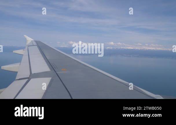 Wing of Wing of plane. A view of the sea and mountains from the plane ...