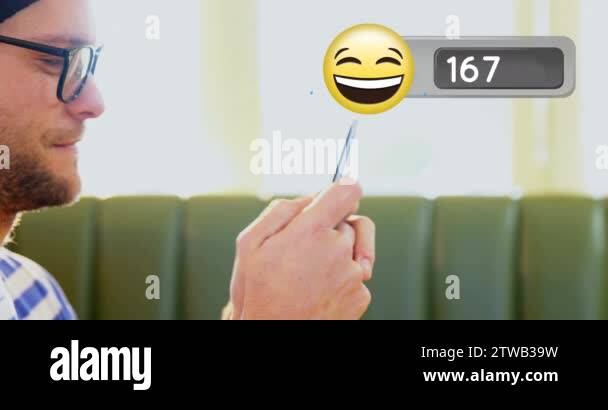 Close up side view of handsome Caucasian man laughing while typing on ...