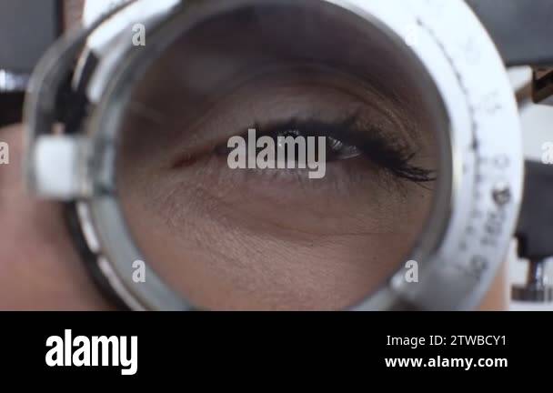 Woman eye with optical trial frame closeup, examination of visual ...
