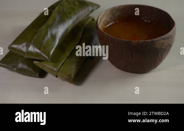 sticky rice wrapped in leaves and served with peanut sauce. Famous ...