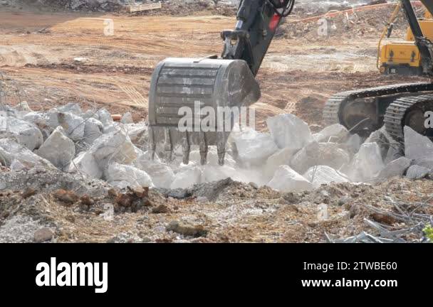 Excavator machine moving debris in the demolition of a building Stock ...