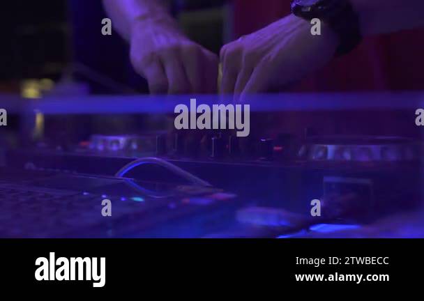Male hand disk jockey on dj deck for mixing house music on disco party ...