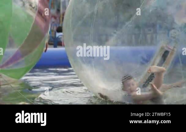 child has fun on the playground. Child in sodium, water ball. little ...