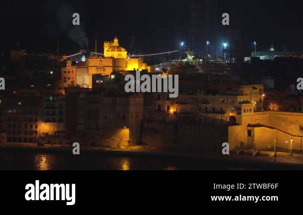 Panoramic night view of a coast line and the downtown of Valletta ...