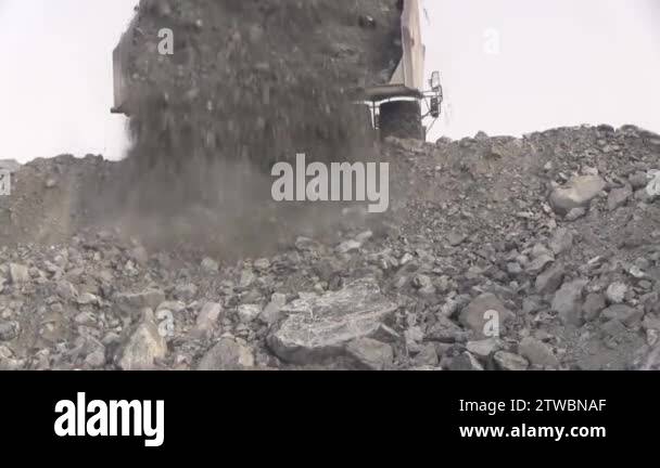 A large dump truck pours 50 tons of ore into the cliff.From the body of ...