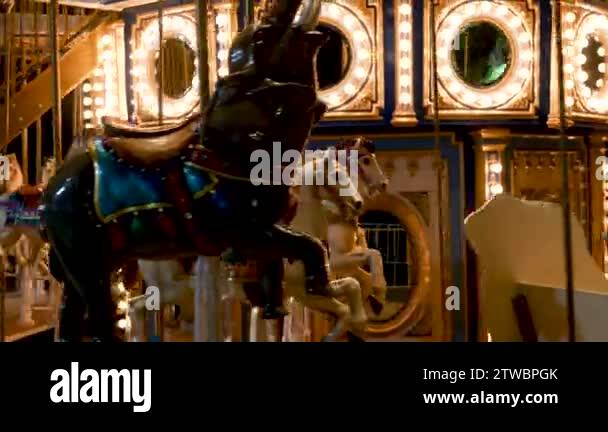 Illuminated merry go round in park. Brightly illuminated roundabout ...
