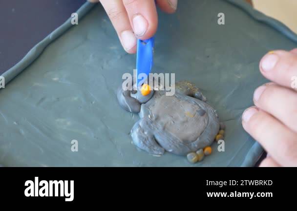 the girl sitting at the table, draws different figures from color model ...