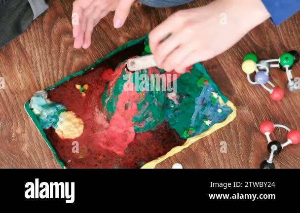 Closeup experience with plasticine volcano erupts foam at home ...