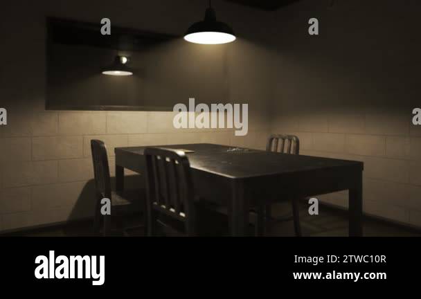 Empty, dark interrogation room with one-way mirror, metal table and ...
