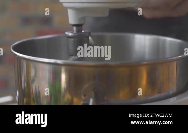 Close up making dough in kitchen mixer. Kitchen kneader machine mixing ...