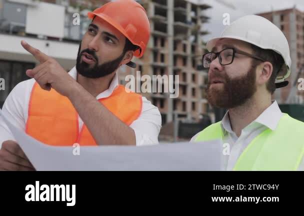 Architect expert engineers talking and analyze design plan standing ...