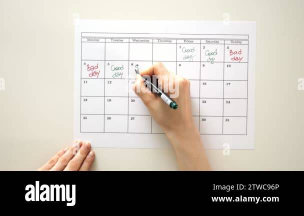 Sign the day in the calendar with a pen, draw a good bad day Stock ...