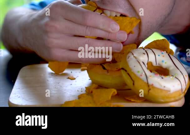 Unhealthy eating man Stock Videos & Footage - HD and 4K Video Clips - Alamy
