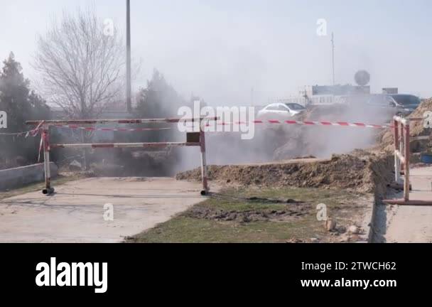 Steam from a broken sewer utility line Stock Video Footage - Alamy