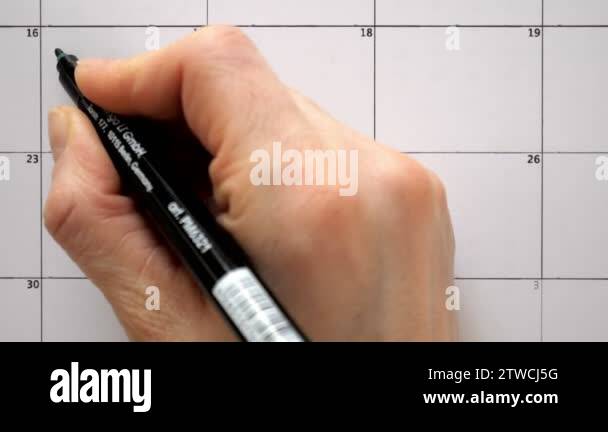 Sign the day in the calendar with a pen, draw a holiday Stock Video ...