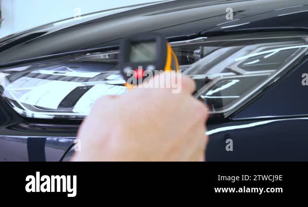 Employee is a professional who polishes a black car, repairs cars ...