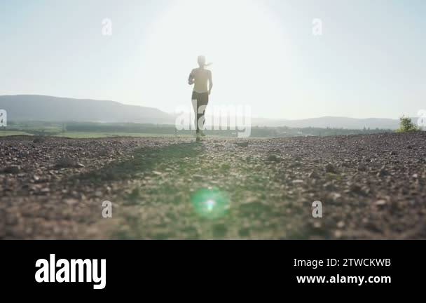 Running young woman trail running in mountain at sunset - female ...
