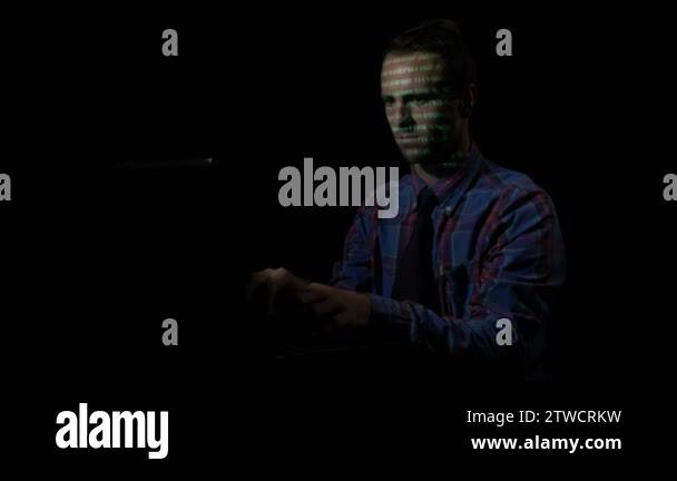 Excited and surprised male hacker focusing and typing codes that are ...